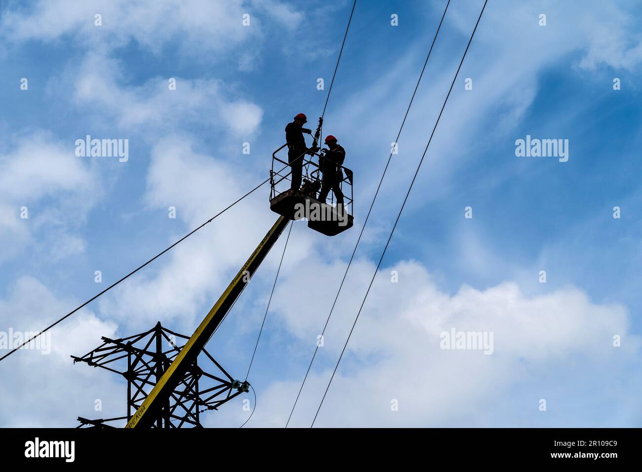 USA. 10th May, 2023. Workers fixing electric power transmission line ...