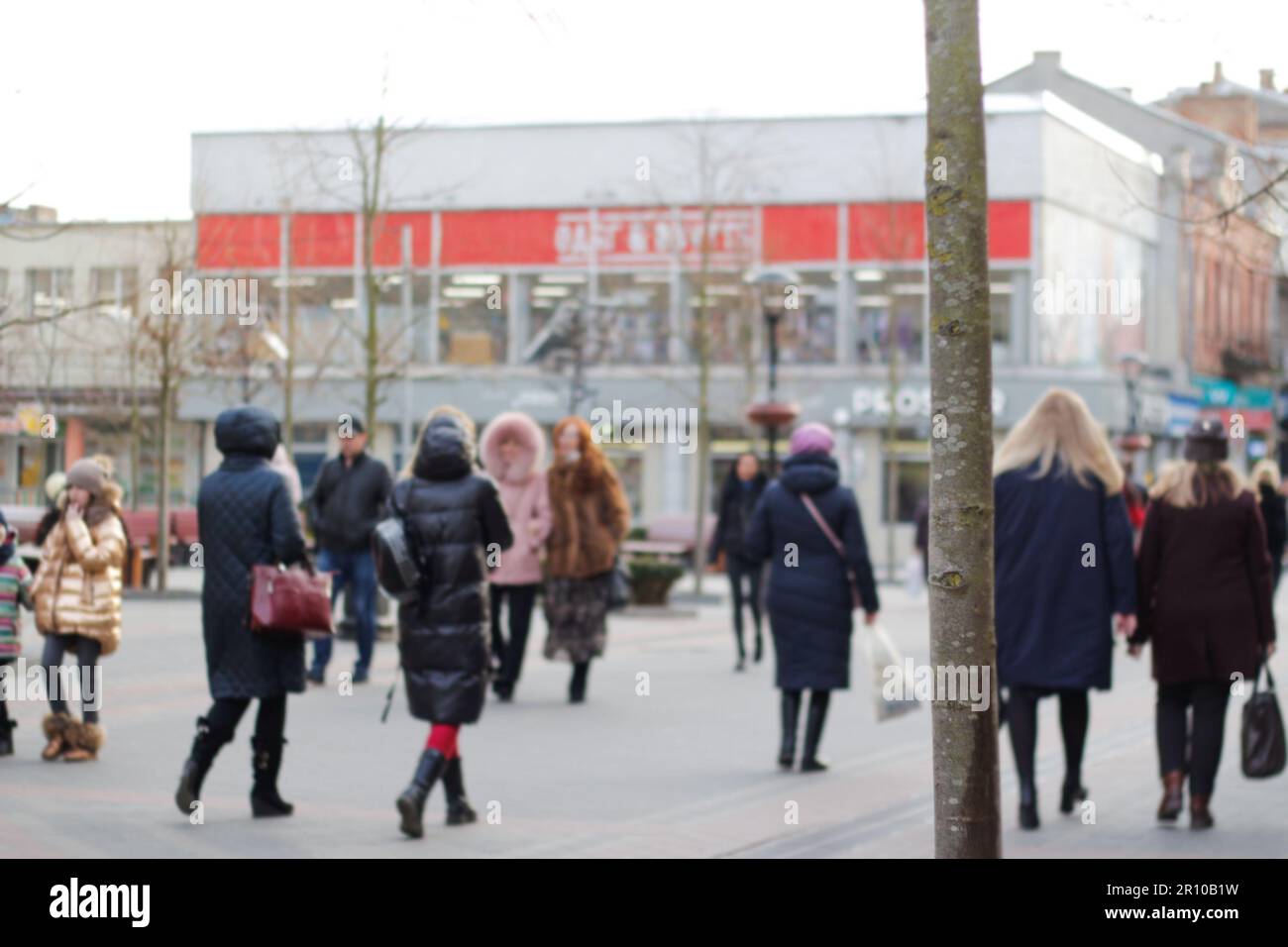 Crowd of people walking on a street in Ukraine. Sad depressed woman ...