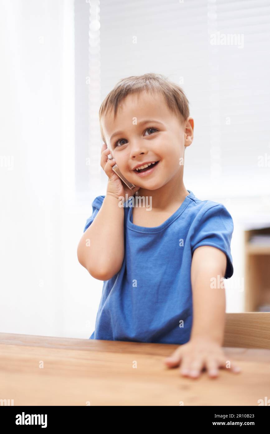 Giving Grandma a call. a young boy talking on a cellphone Stock Photo ...