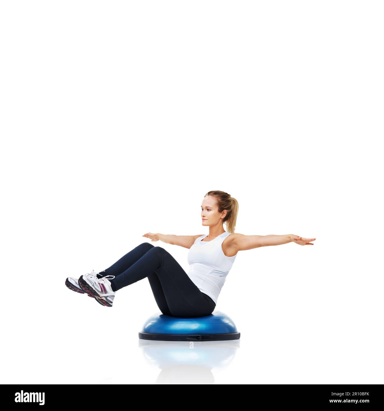 Using balancing to increase her core strength. An attractive young ...