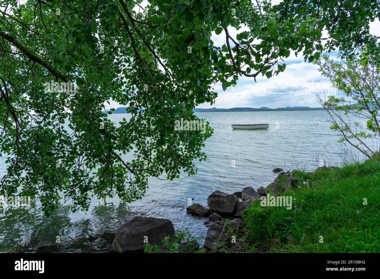 boat on Lake Balaton with Badacsonyhill background in Balatonlelle with ...
