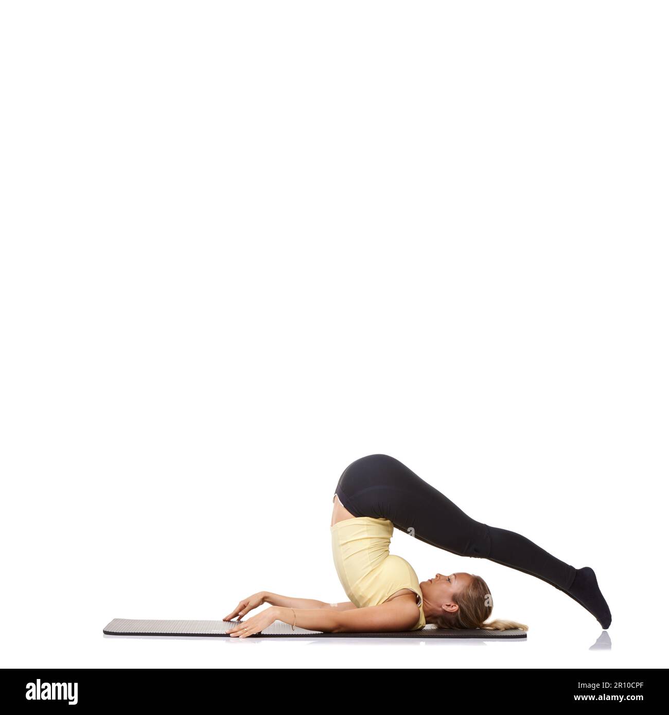 Flexibility and fitness. A fit young woman lying on her back and ...