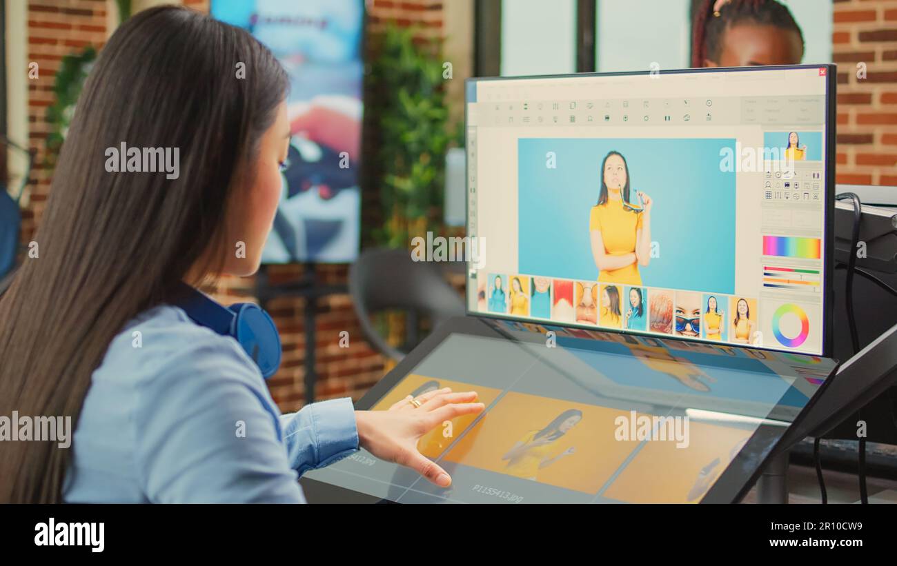Female colorist editor using retouching software with tablet, working ...