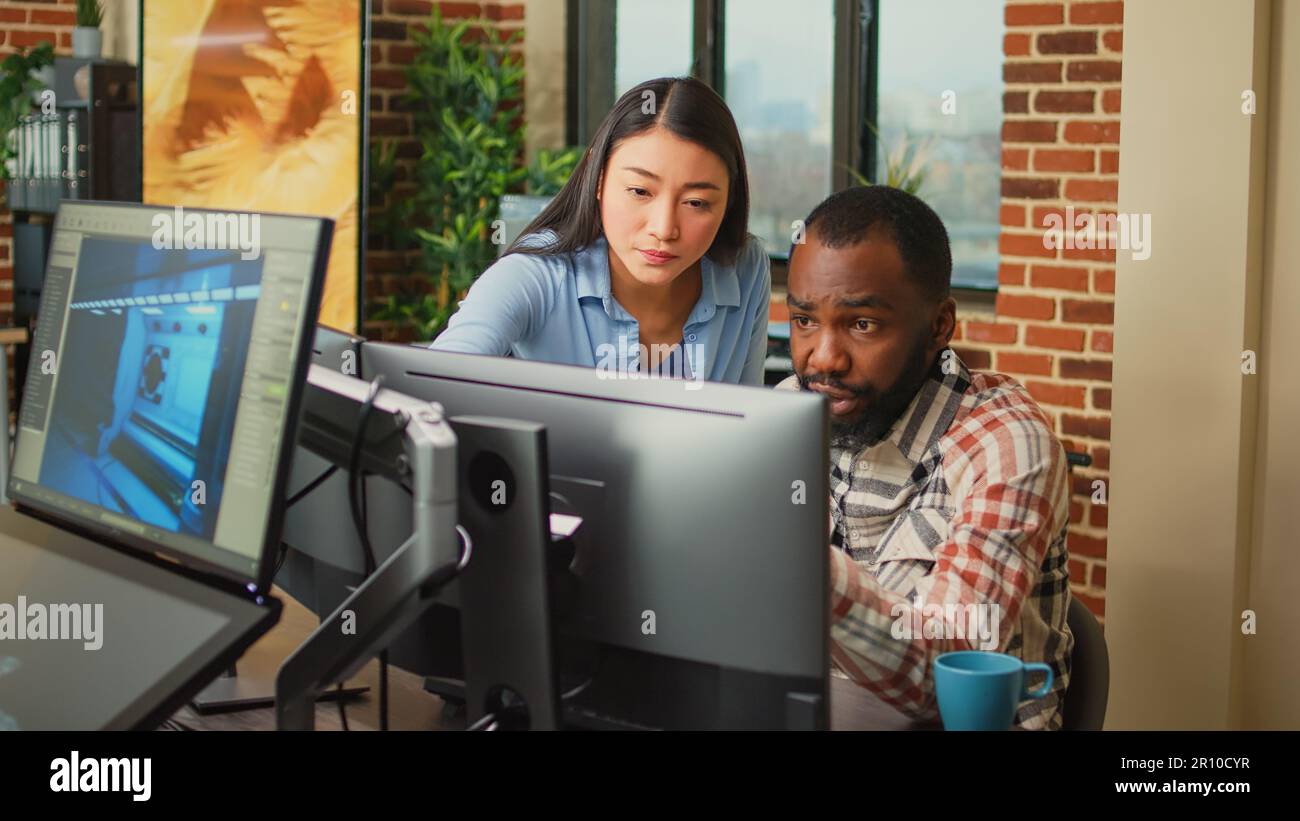 Modern technology studio employees using computers to develop new ...