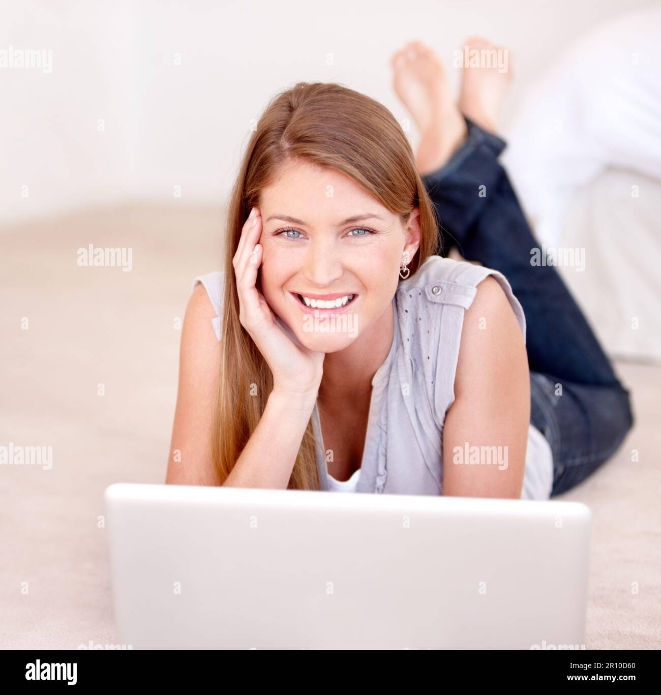Happy, laptop and floor with portrait of woman in living room for ...