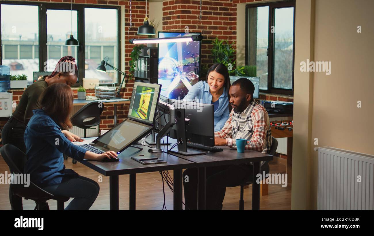Modern technology studio employees using computers to develop new ...