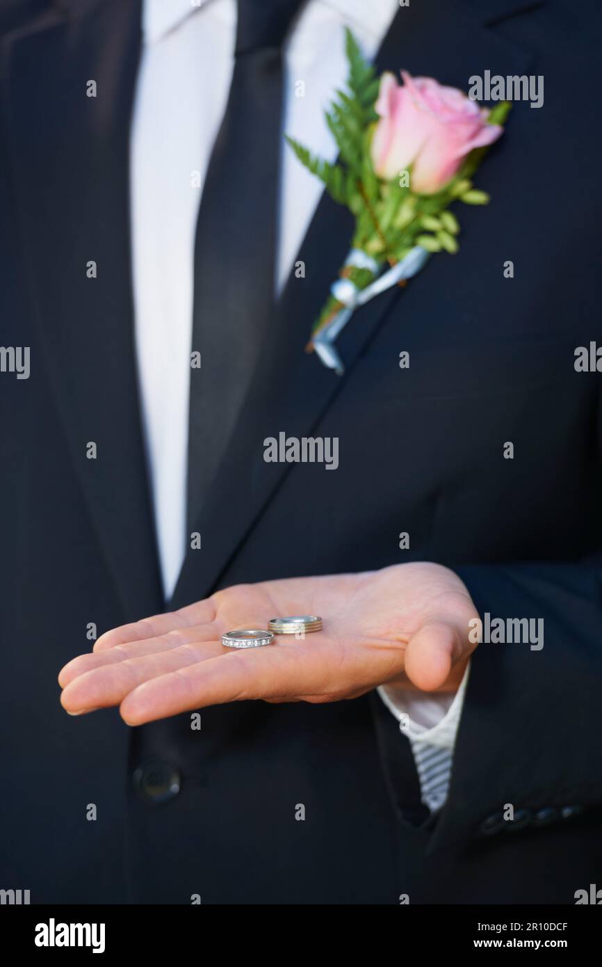 Giving the rings to his best man. Cropped closeup of a groom with the ...