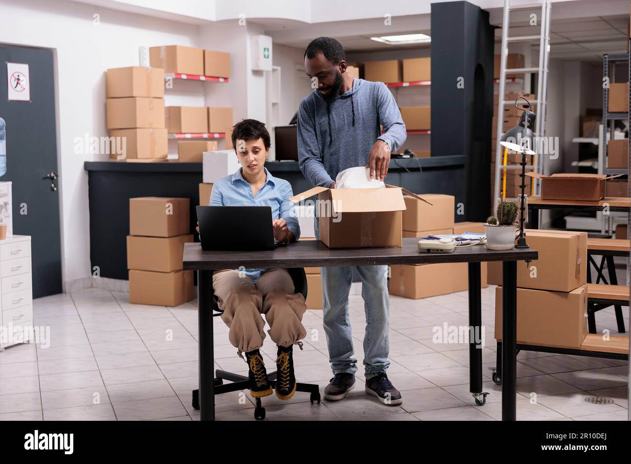 Supervisor woman sitting at desk browsing client transportation details ...