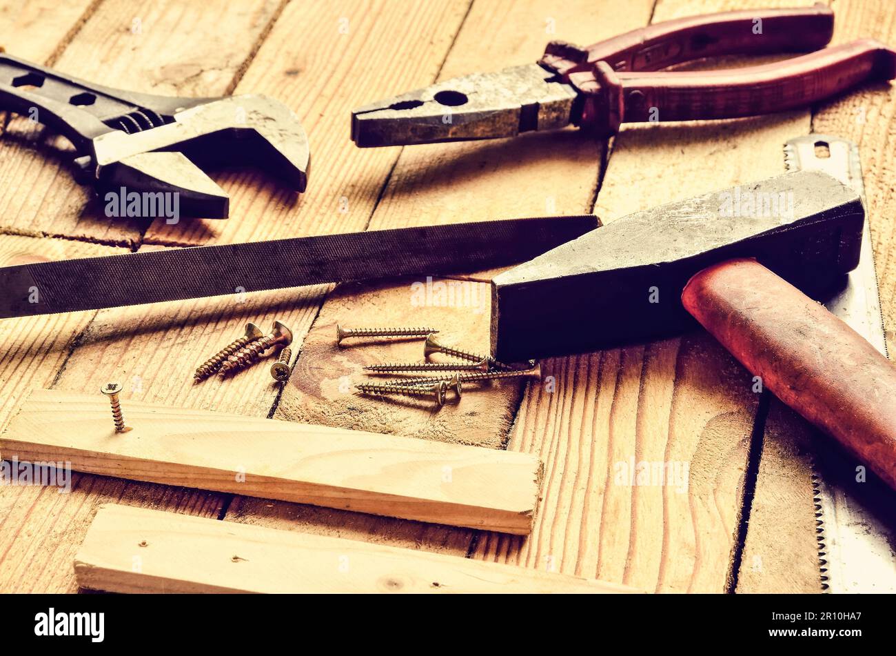 Renovation tools on the table. Hammer, flat file, pliers, screwdriver ...