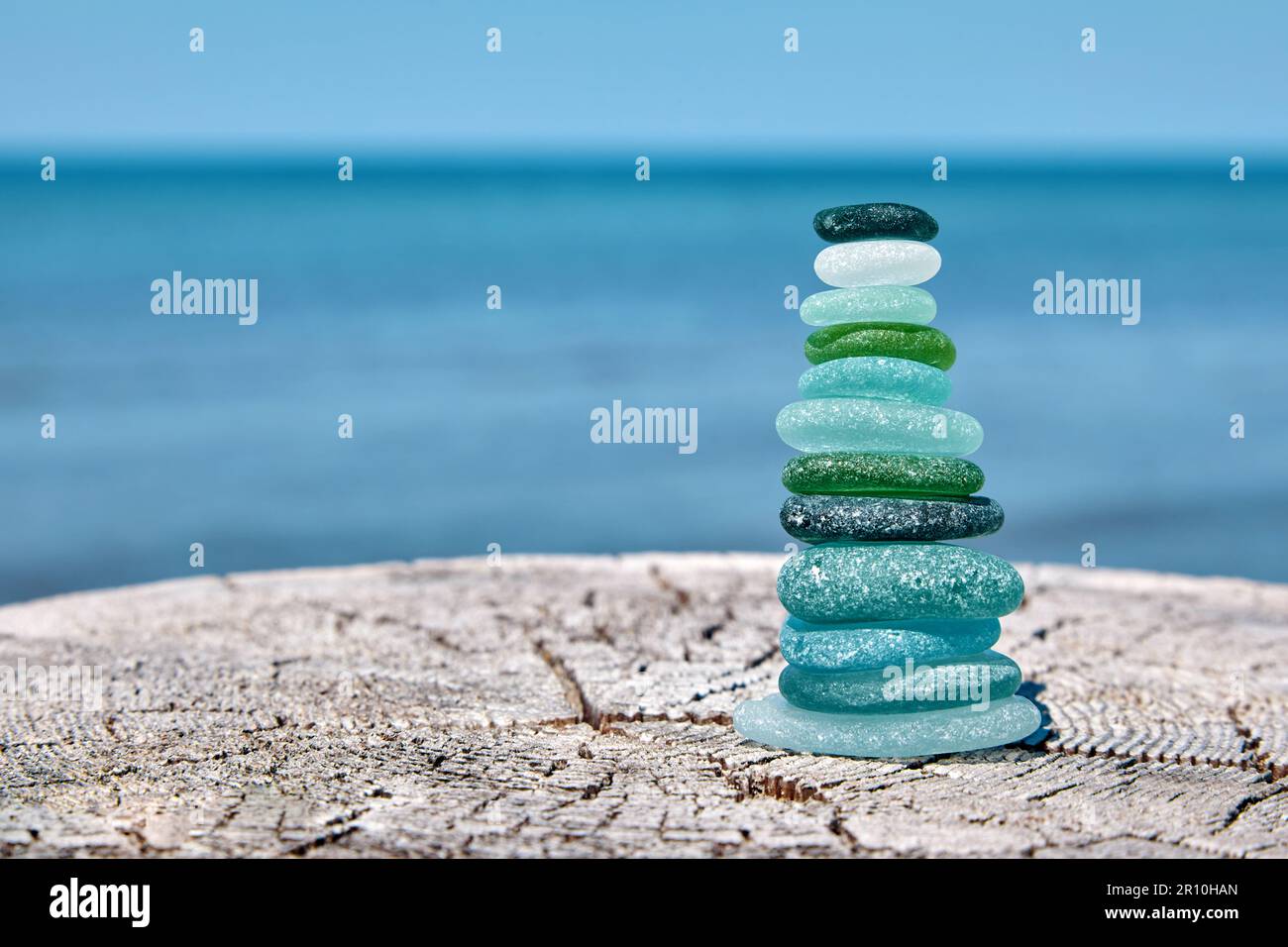 Balanced pyramid of sea-polished glass bottle shards on a weathered ...