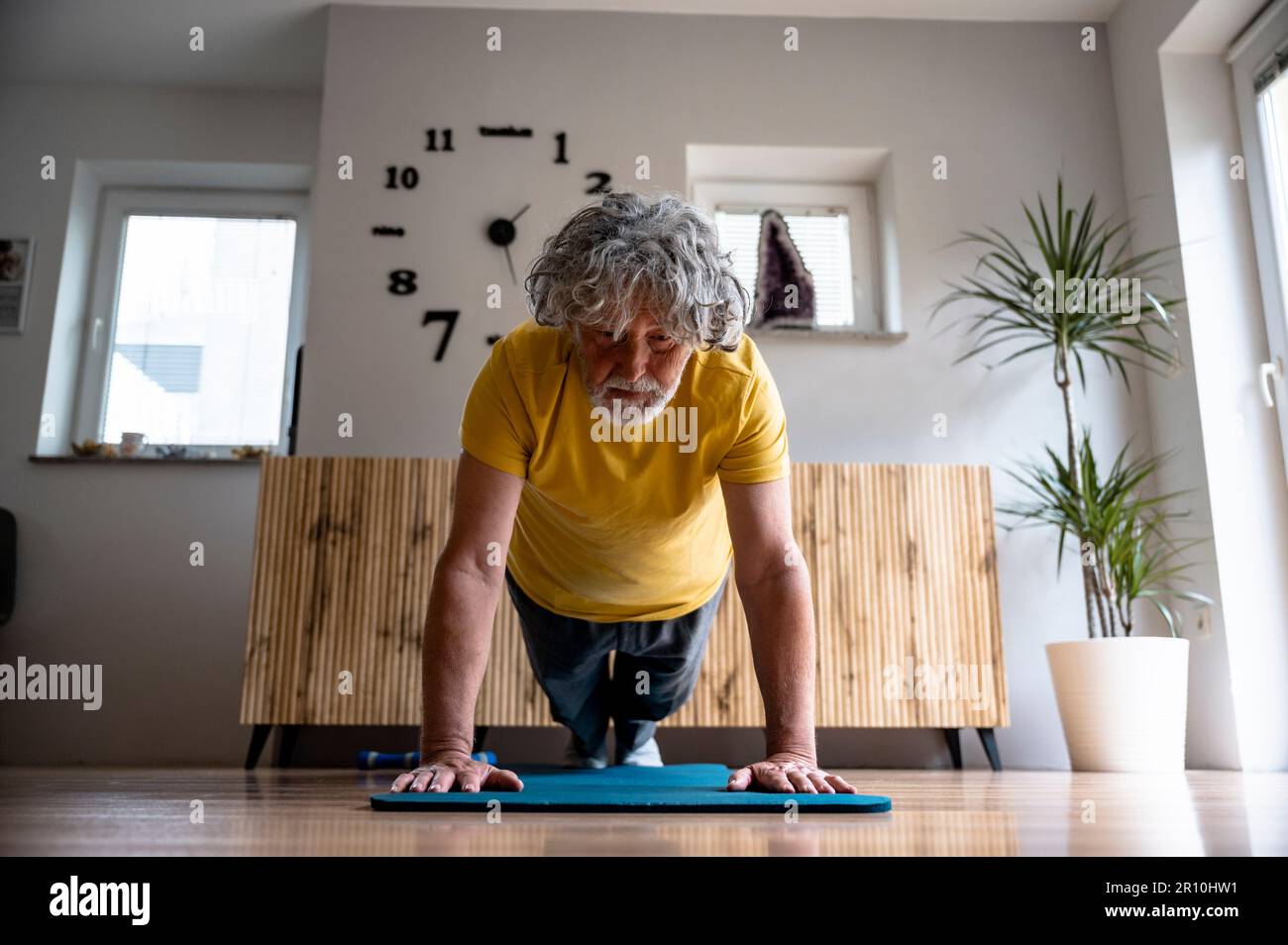 Low angle front view of a senior man living an active life working out ...