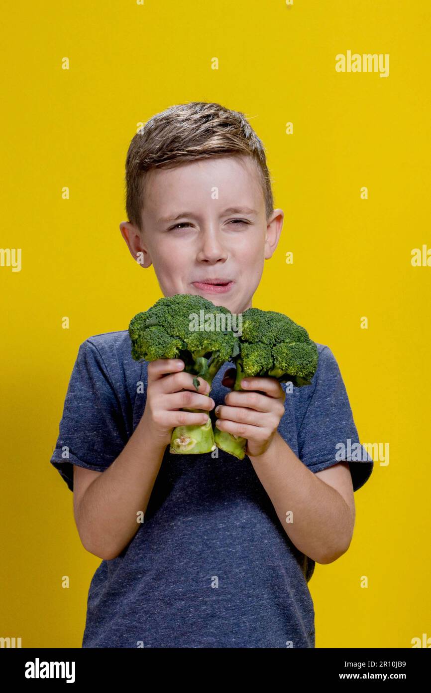 A charming little boy refusing to eat broccoli. Brootish broccoli Stock ...