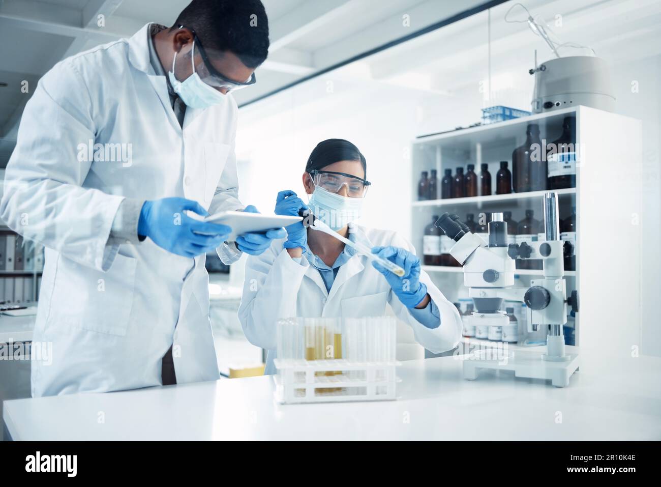 Up to the task of saving lives. two young scientists conducting medical ...