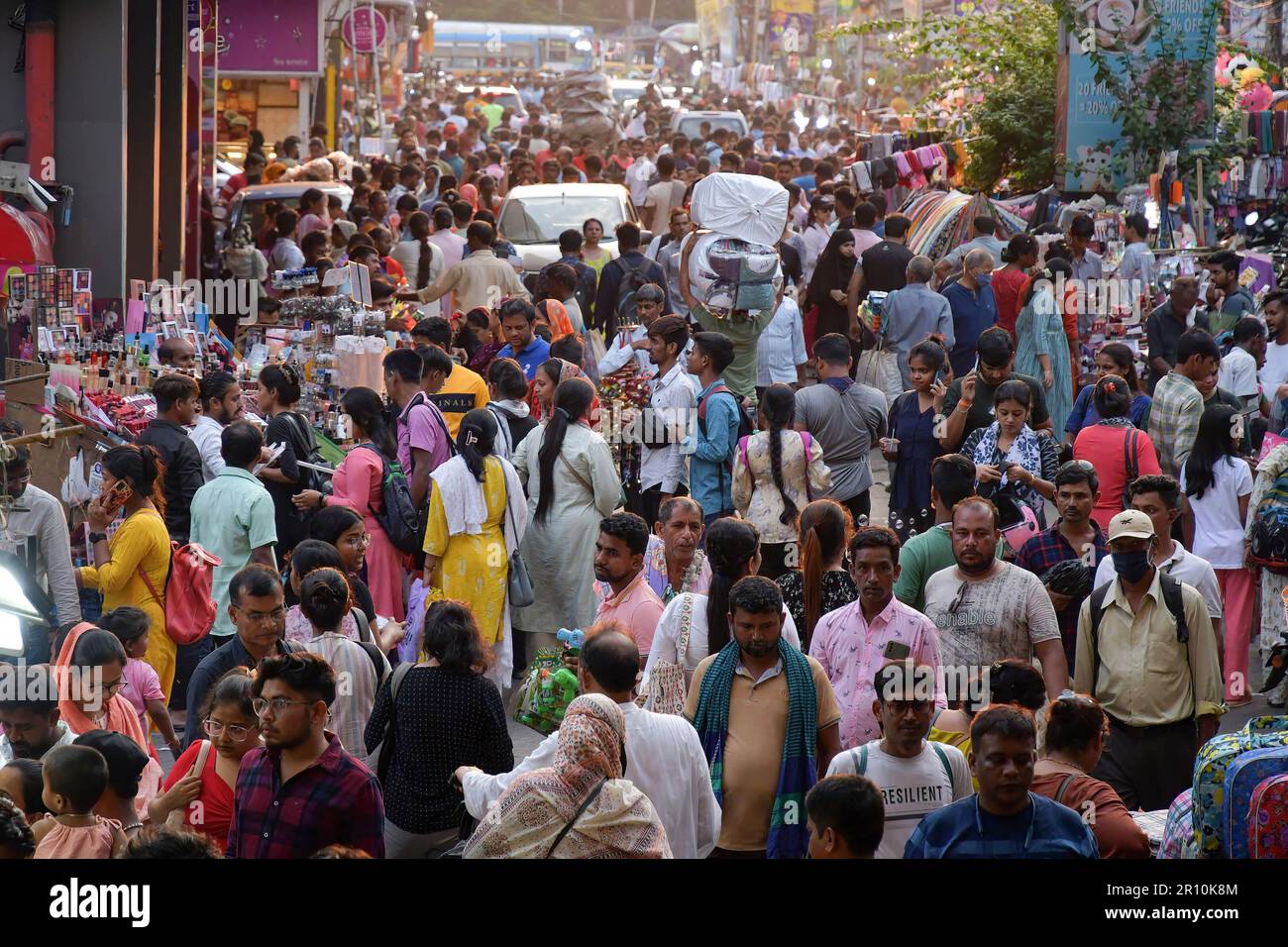 People seen shopping at a crowded market in Kolkata. India's population ...