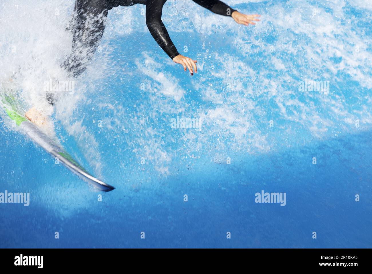 A surfer practicing in a wave pool balancing on a crest Stock Photo - Alamy