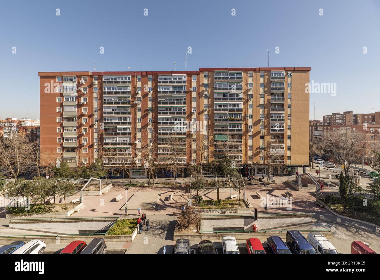 Main facades of buildings in a large open space with parks and parking ...