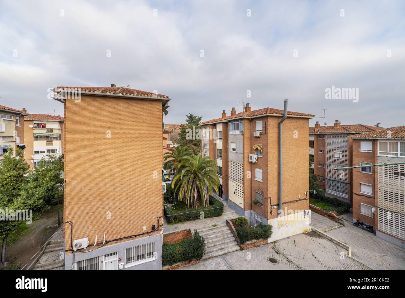 View of facades of residential buildings with gardens and trees in ...