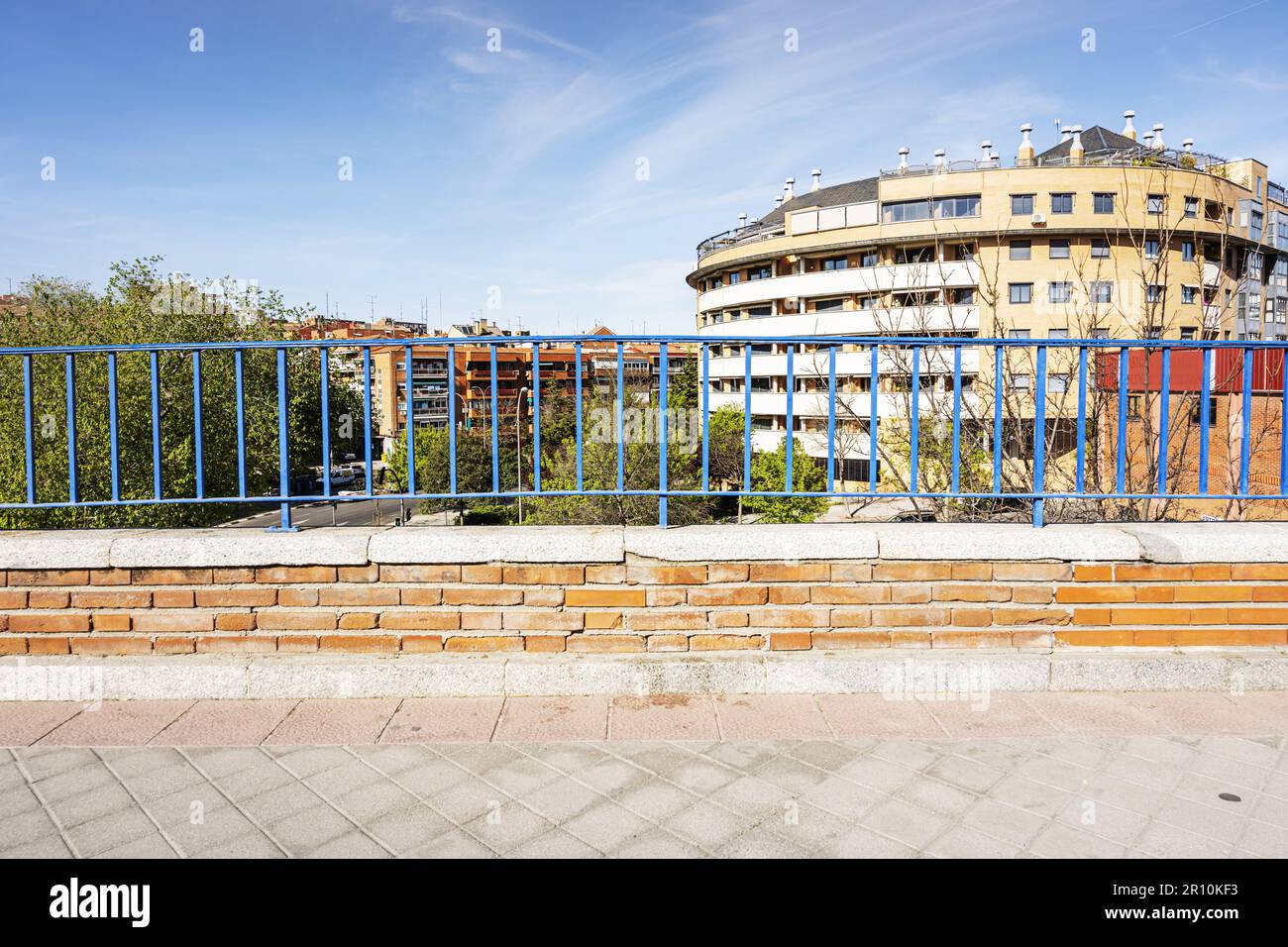Views of the city from a bridge with blue railing Stock Photo - Alamy