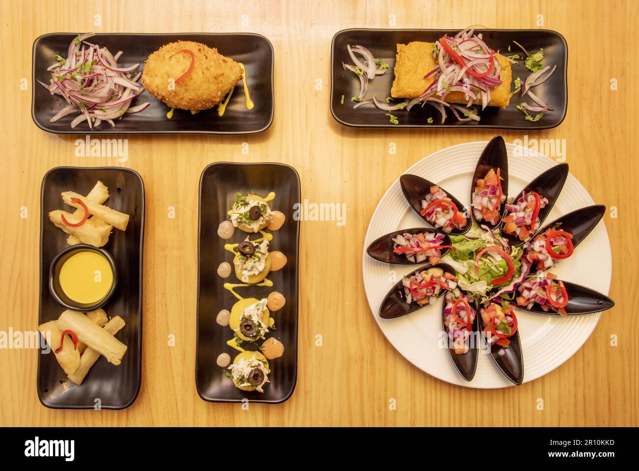 A set of delicious Peruvian food dishes with mussels with pico de gallo ...