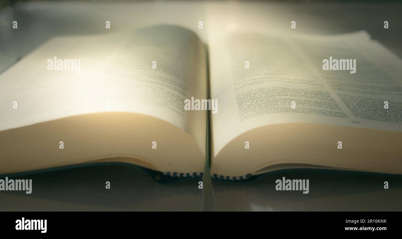 Glowing pages of an open book close-up slow-motion. Reading knowledge ...