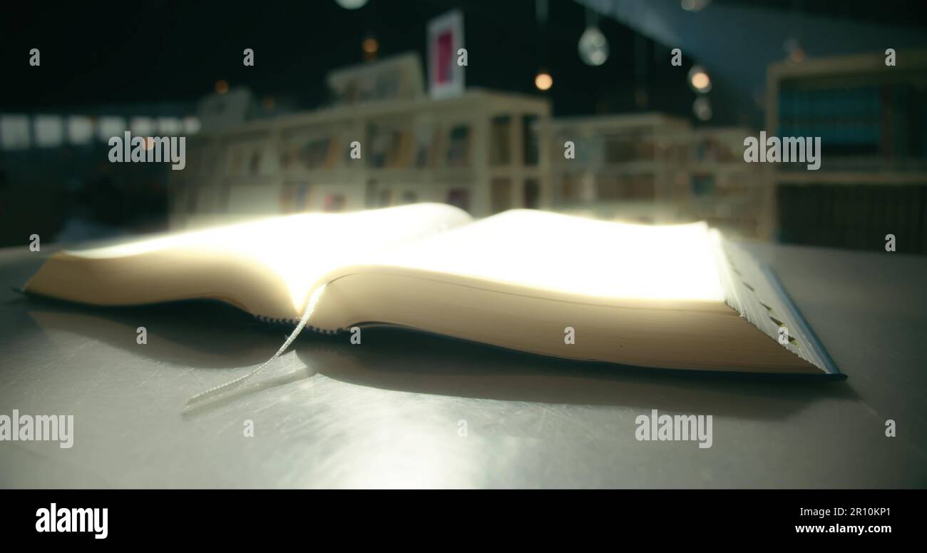 Glowing pages of an open book close-up slow-motion. Reading knowledge ...