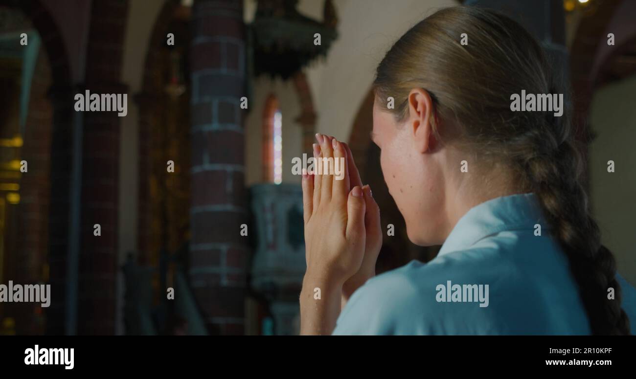 Woman praying to God with HOPE and FAITH in church. Close-up religious ...