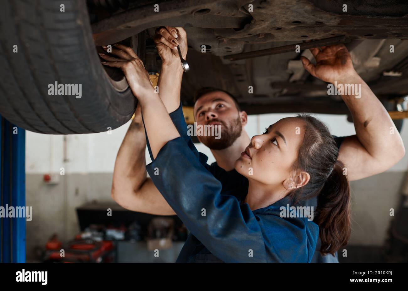 They put the care in autocare. two mechanics working together under a ...