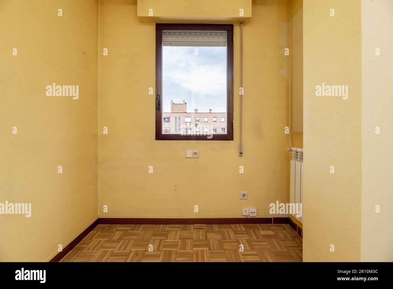 Large empty room with oak parquet floors and access doors Stock Photo ...