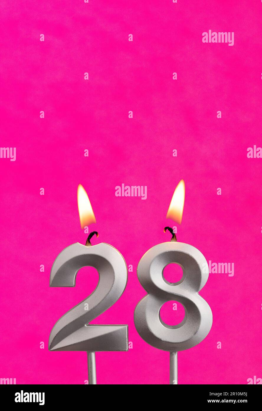 Candle 28 with flame - Silver anniversary candle on a fuchsia ...