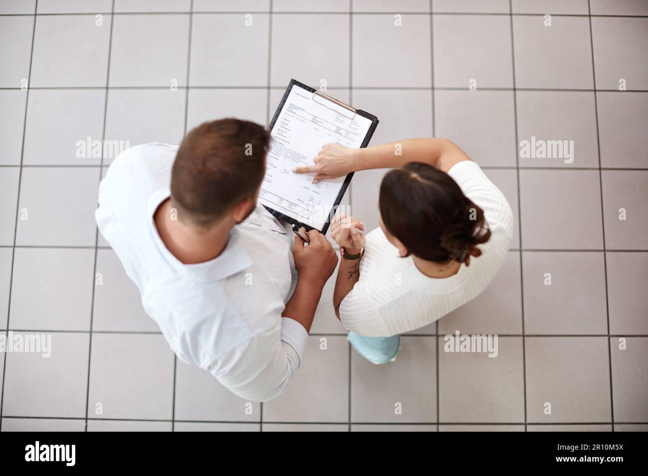 What does this mean. a customer reading over paperwork with her ...