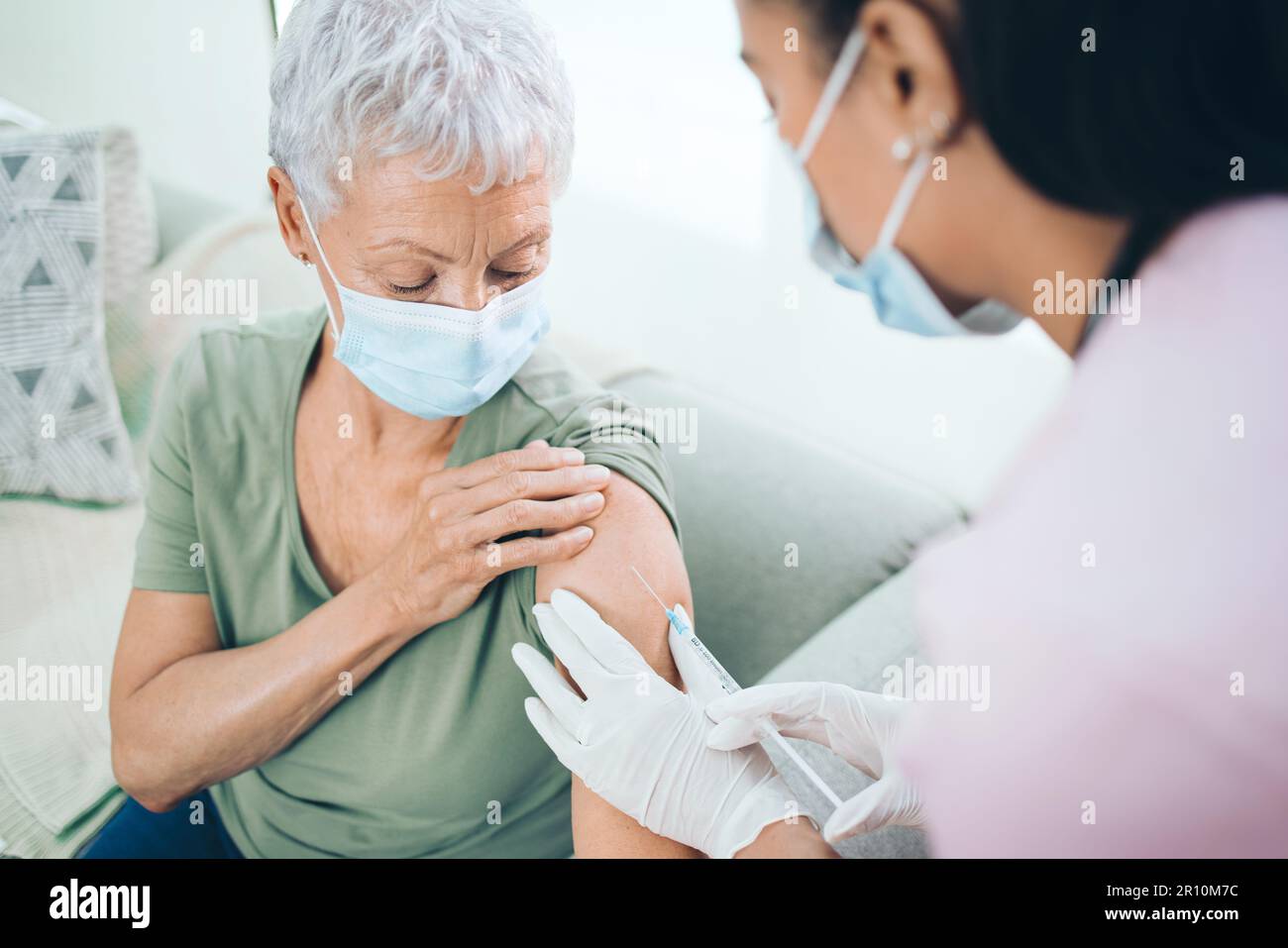 Tomorrow will take care of itself. a doctor giving a masked older woman ...