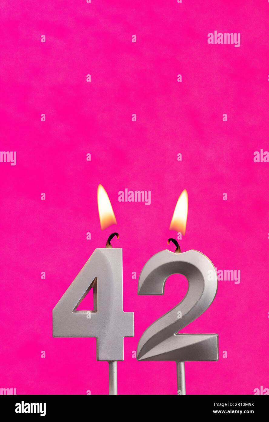Candle 42 with flame - Silver anniversary candle on a fuchsia ...