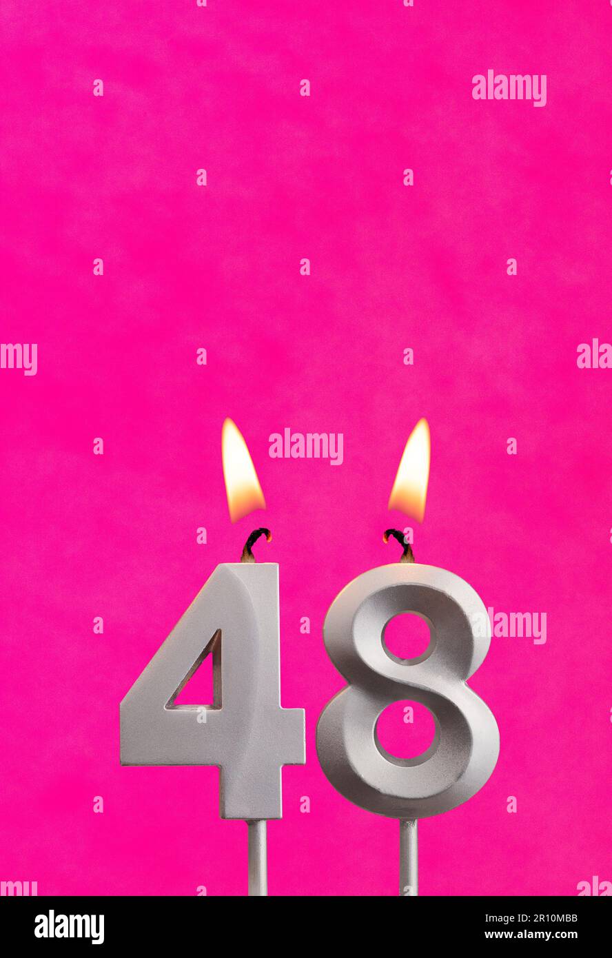 Candle 48 with flame - Silver anniversary candle on a fuchsia ...