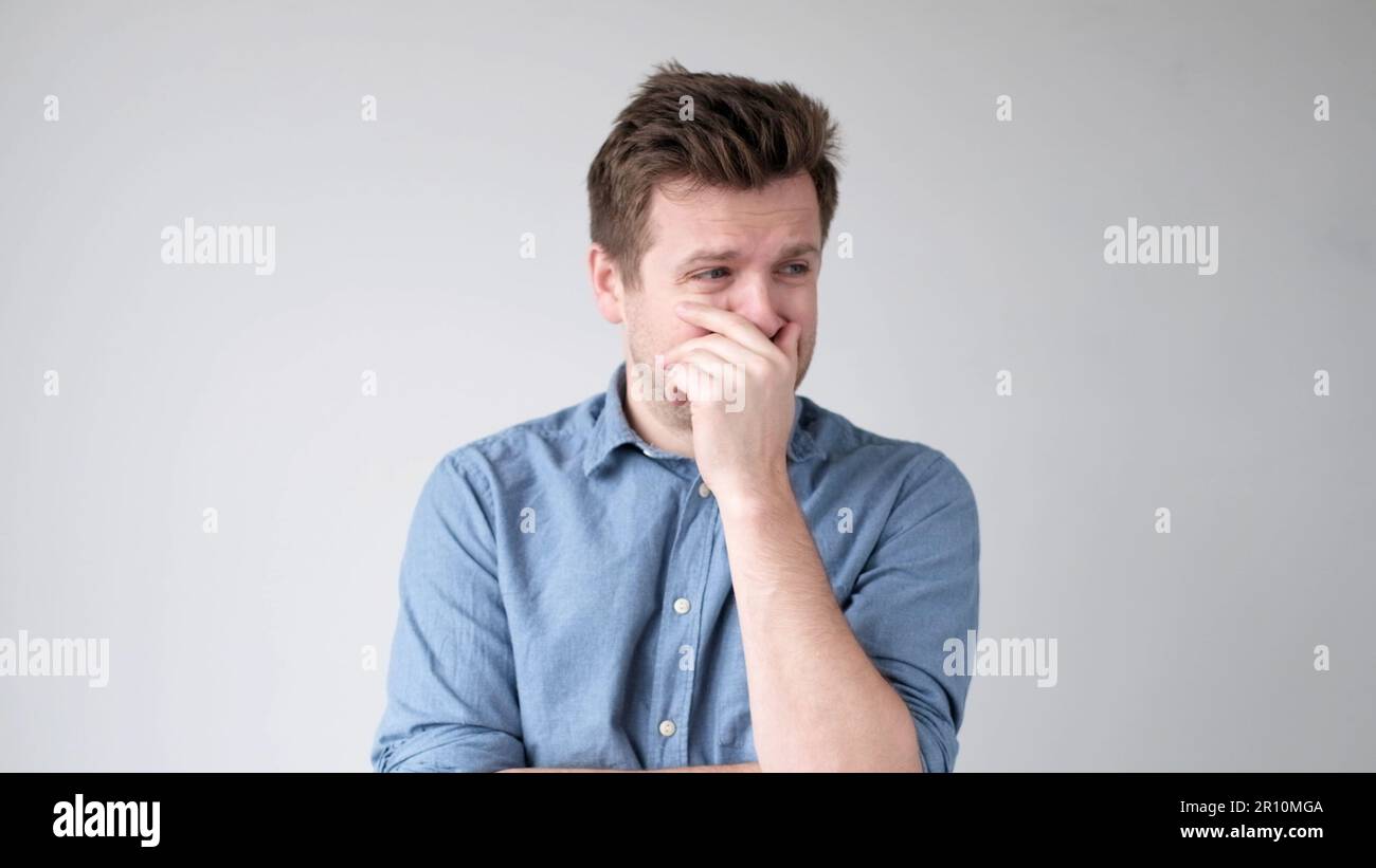 European young man barely holding back tears from problems and stress ...