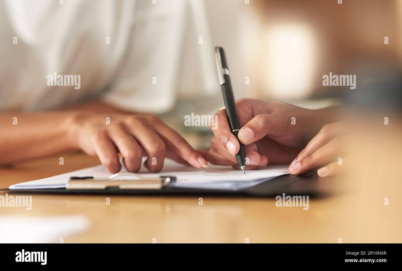 Making commitments to the future. a businesswoman signing a contract at ...