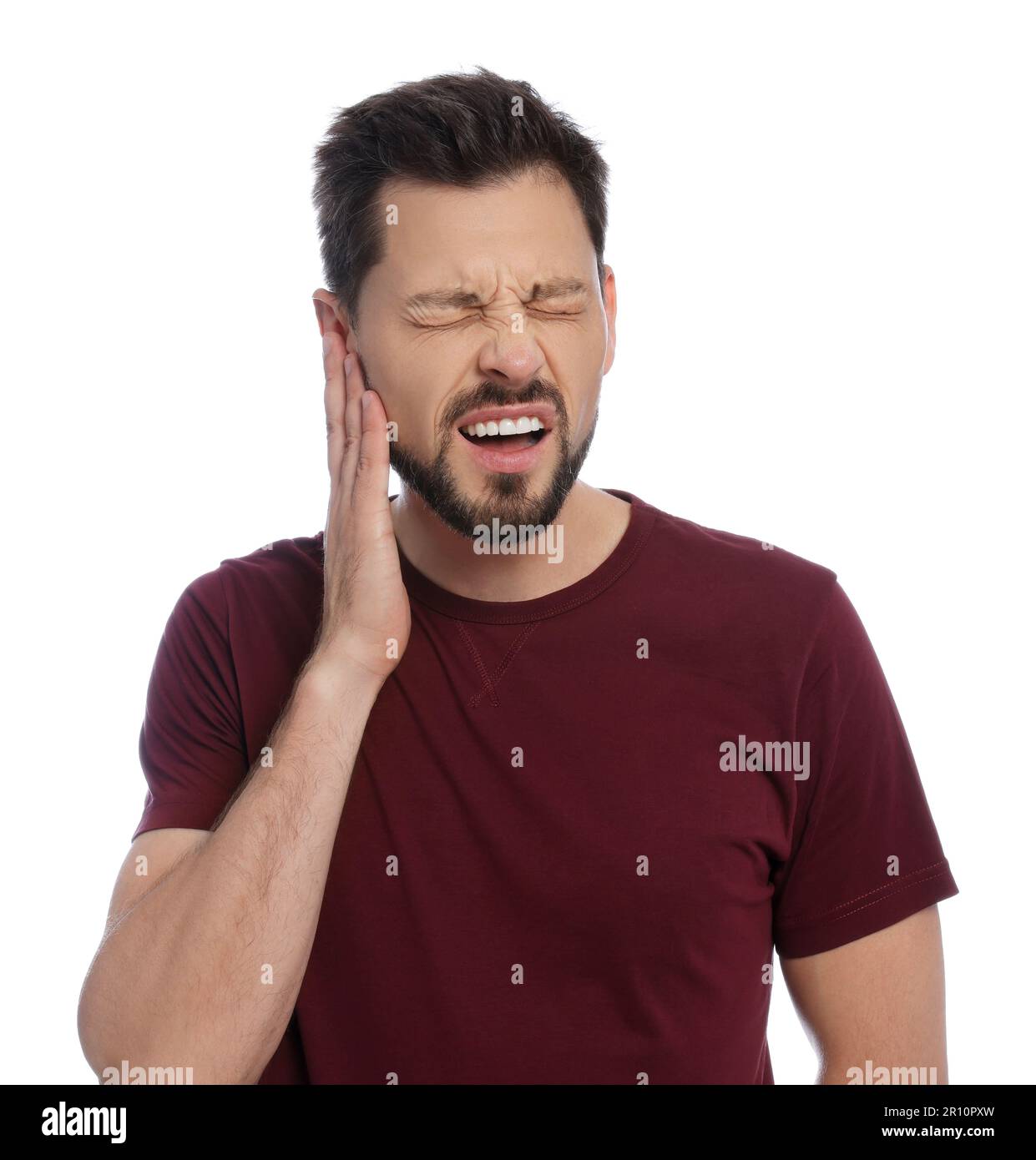 Man suffering from ear pain on white background Stock Photo - Alamy