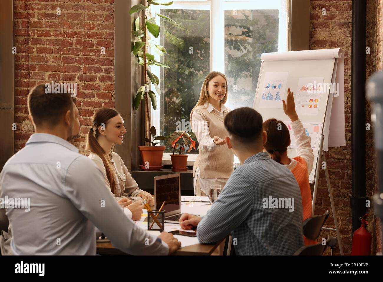 Employees having meeting in office. Team work Stock Photo - Alamy