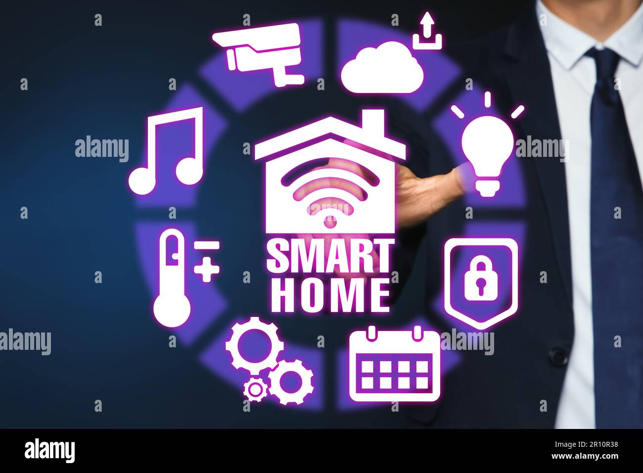 Man using digital screen with Smart Home interface on dark blue ...