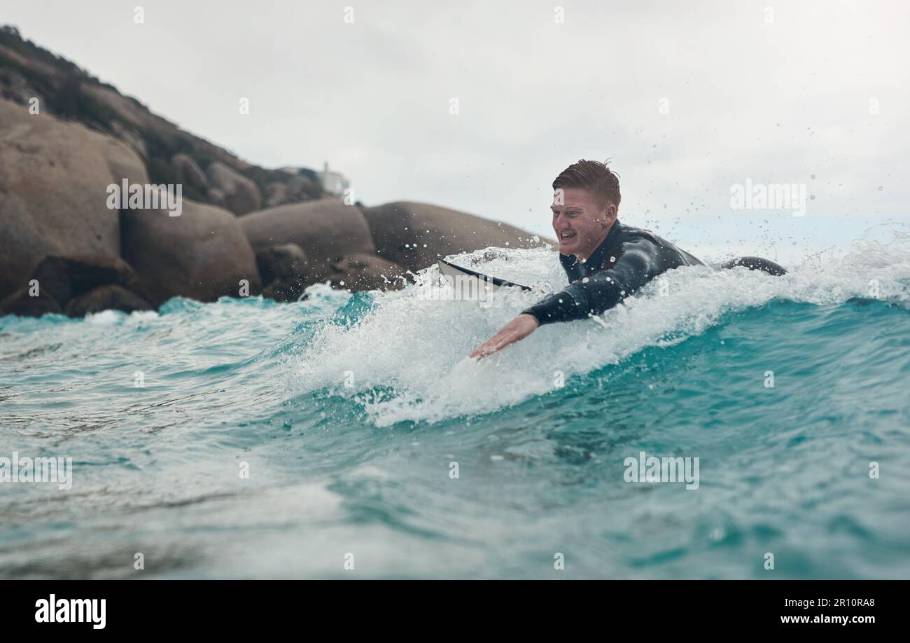 Surfing connects you to nature like no other sport. a young man out ...