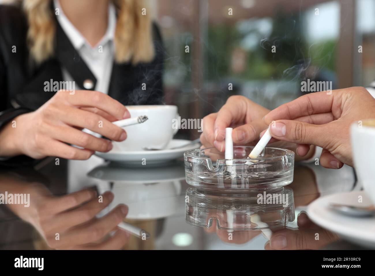 Woman putting out cigarette hi-res stock photography and images - Alamy