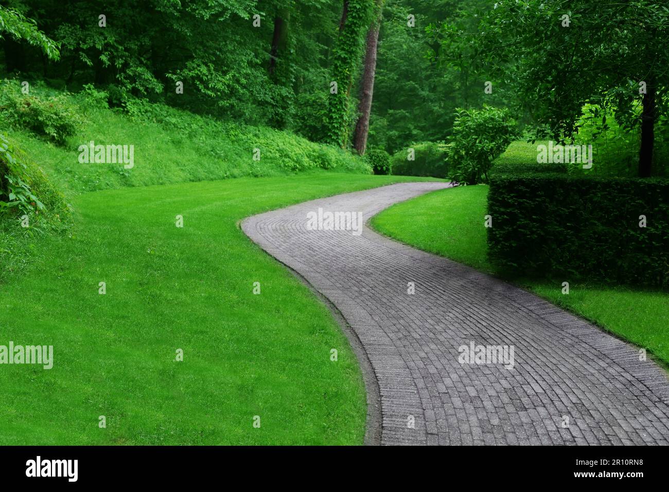 Beautiful green park with paved pathway. Landscape design Stock Photo ...