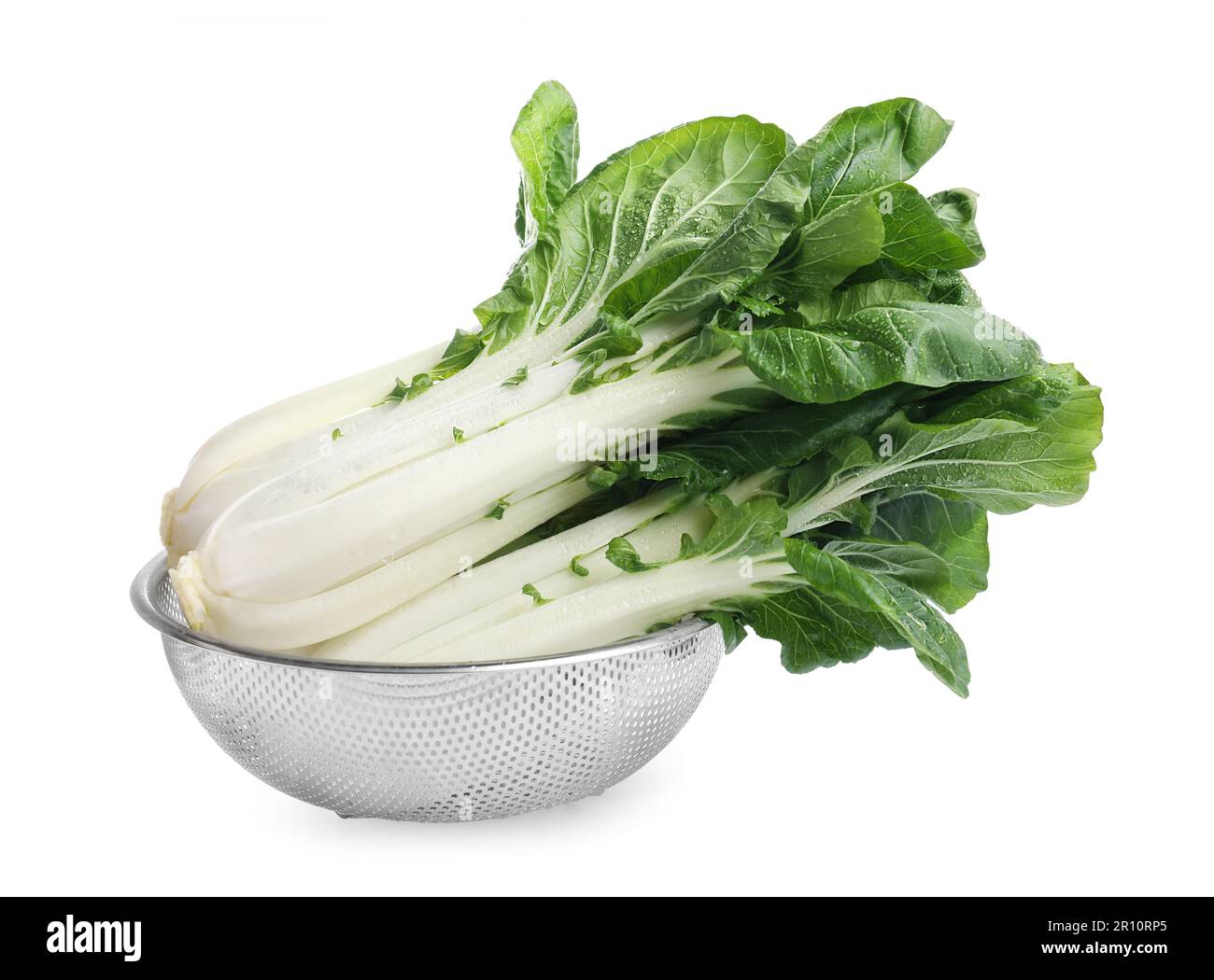 Fresh green pak choy cabbages with water drops in sieve on white ...