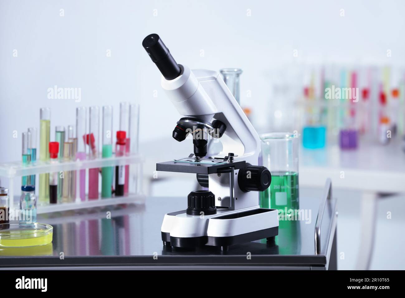 Modern microscope with glass slide on metal table in laboratory Stock ...