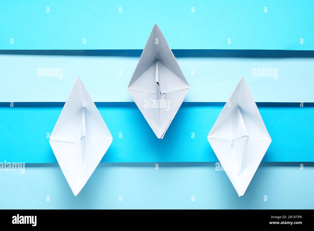 Competition concept. Paper boats on colorful background, flat lay Stock ...