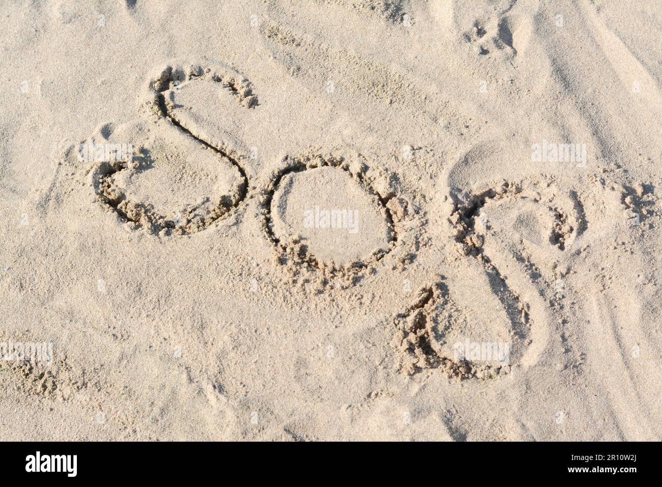 Sos message written on sand hi-res stock photography and images - Alamy
