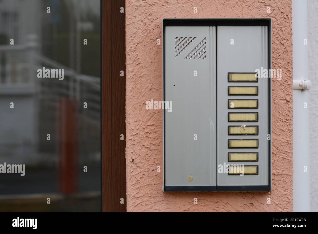 Modern intercom hanging on beige wall outdoors Stock Photo - Alamy