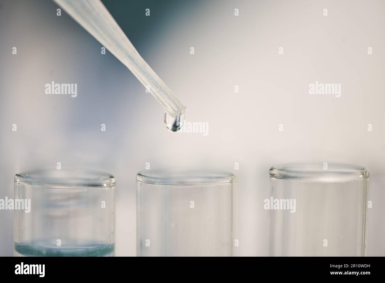 Time to do some tests. Closeup shot of liquid from a dropper falling ...