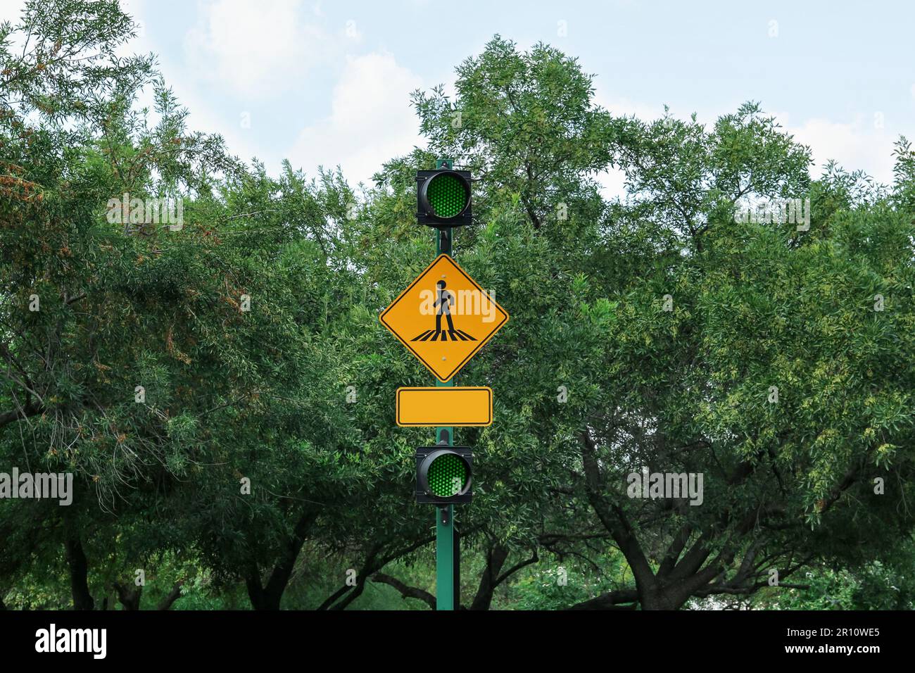 Road rules. Post with traffic lights and sign Pedestrian Crossing ...