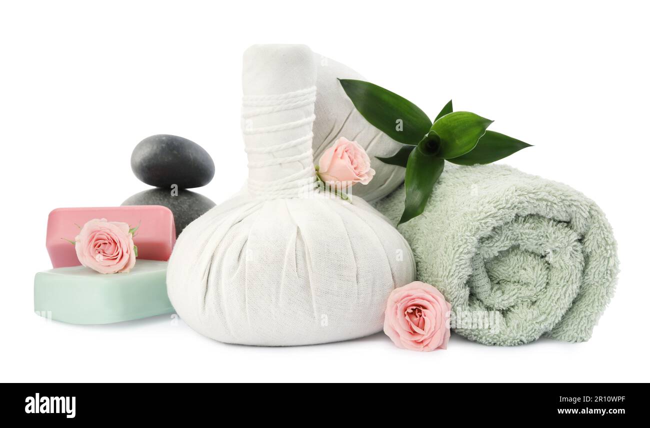 Herbal massage bags, soap, towel and spa stones on white background ...