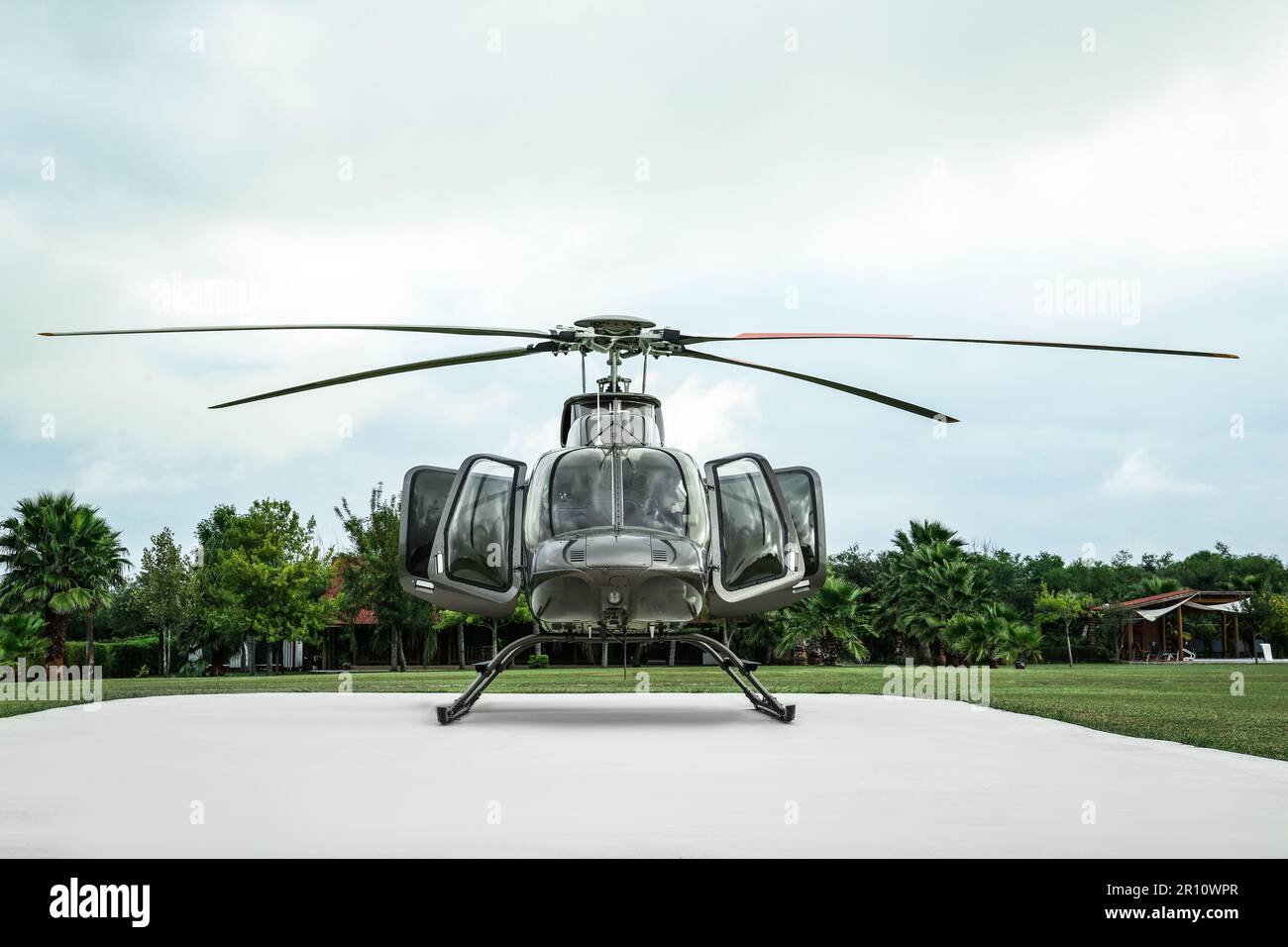 Beautiful modern helicopter on helipad in field Stock Photo - Alamy